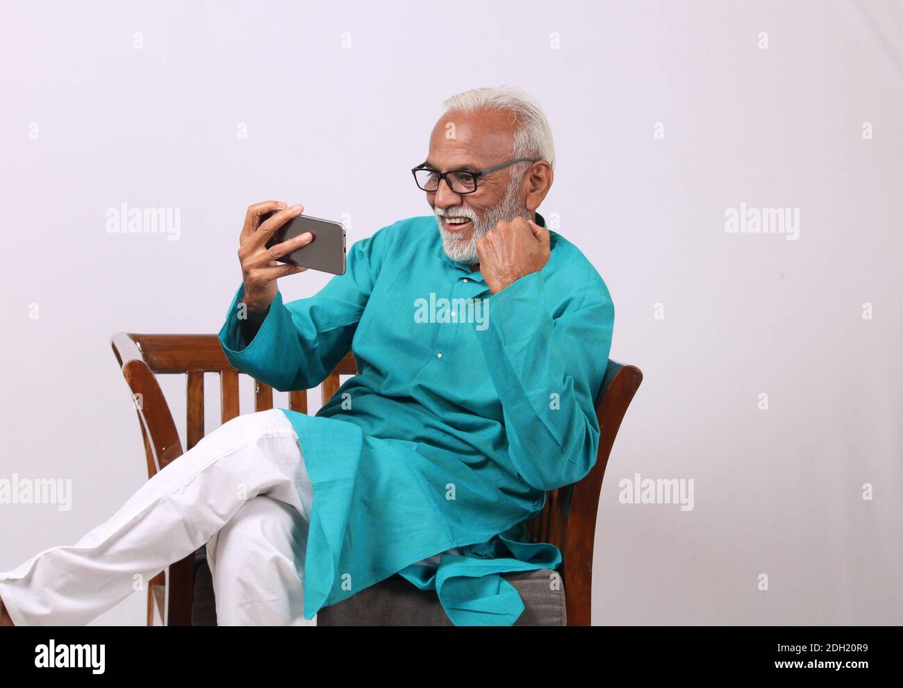 Cool bearded indian old man using mobile phone Stock Photo - Alamy