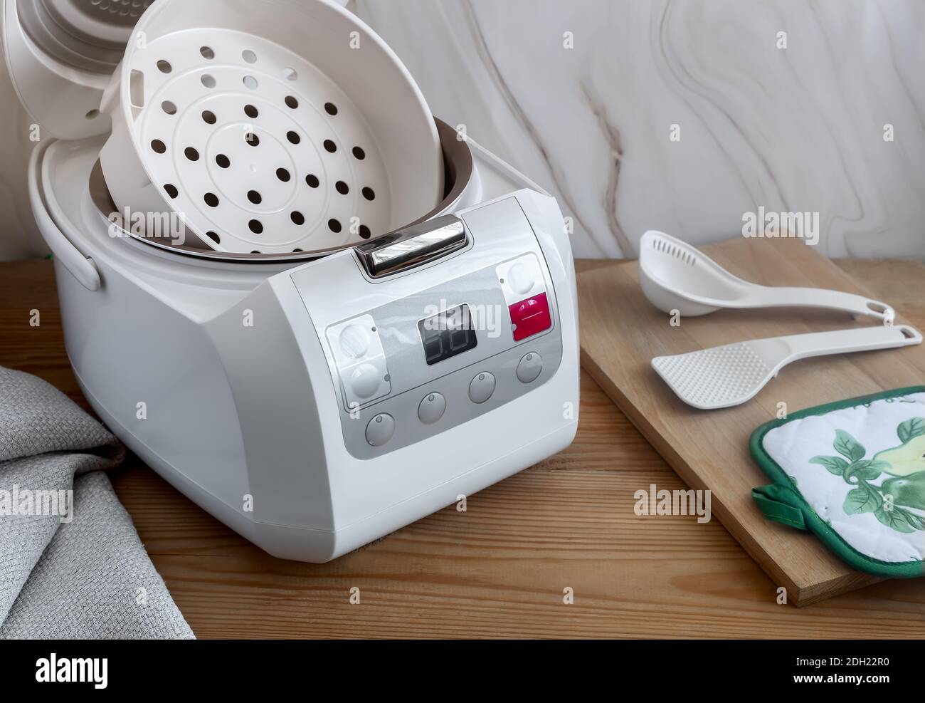 Modern electric multi-cooker and a set of kitchen accessories Stock ...