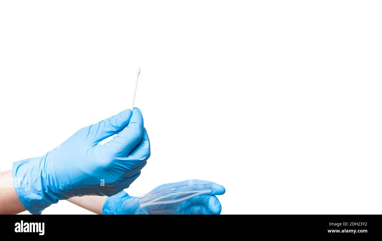 doctor hand in blue sterile glove holds sealed bag and give cotton swab ...