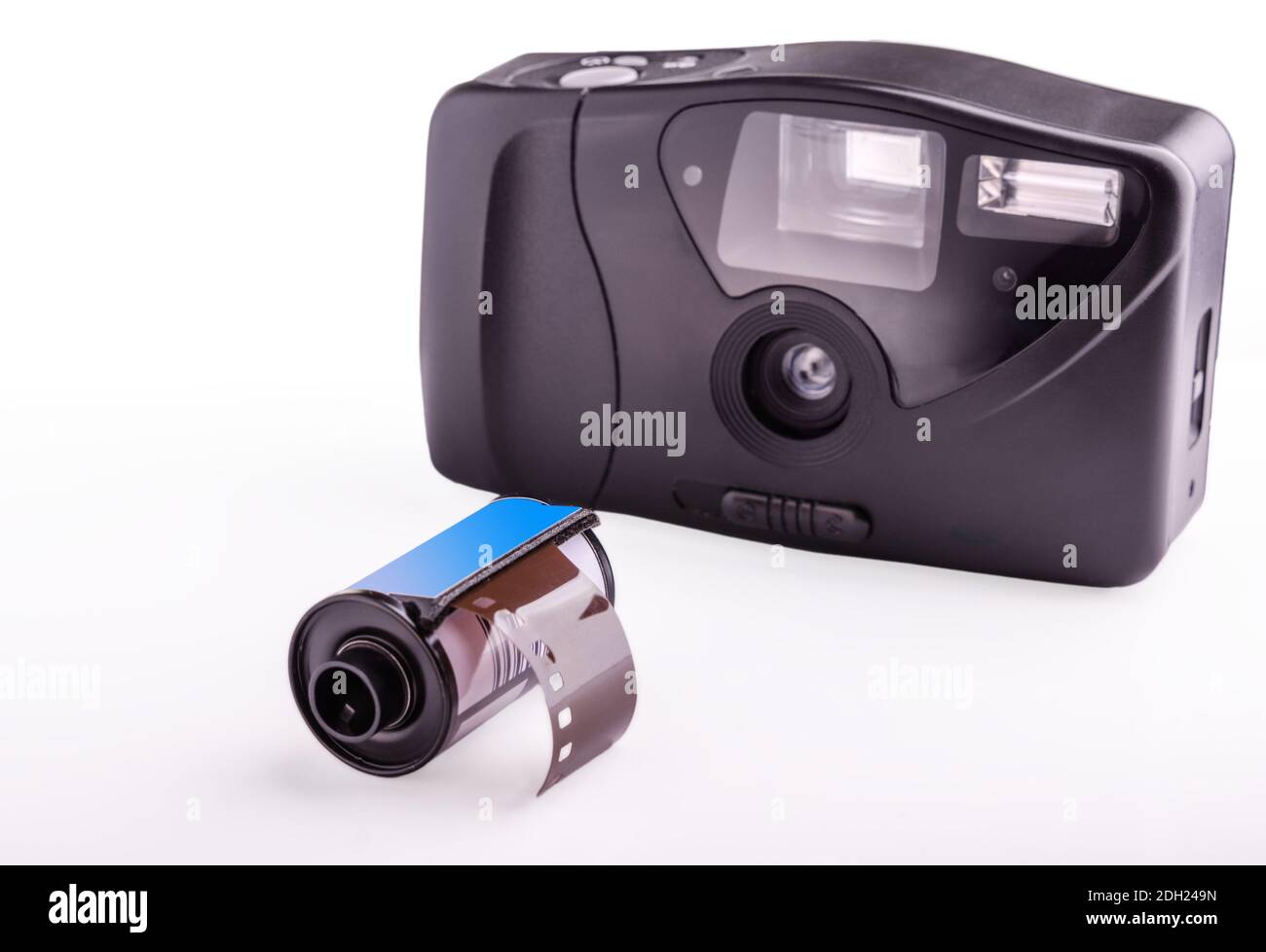 film cassette and compact old analog camera on a white background ...