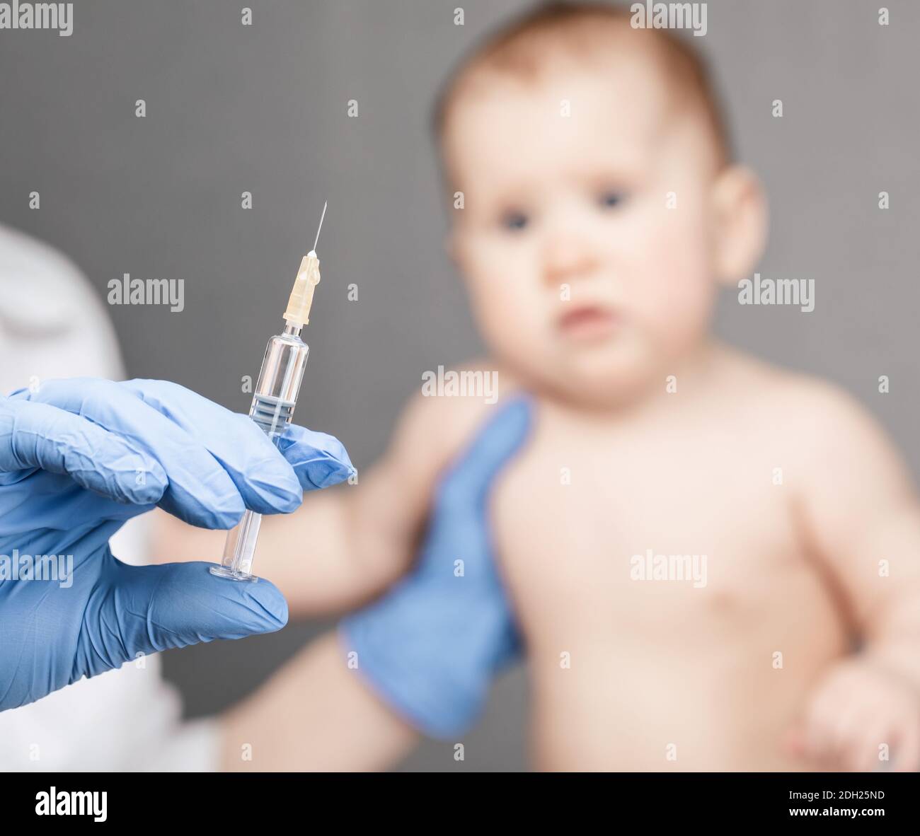 Pediatrician or nurse ready to give an intramuscular injection of a ...