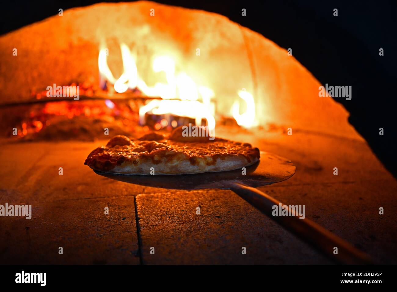 Rustic pizza in wood fired oven Stock Photo - Alamy