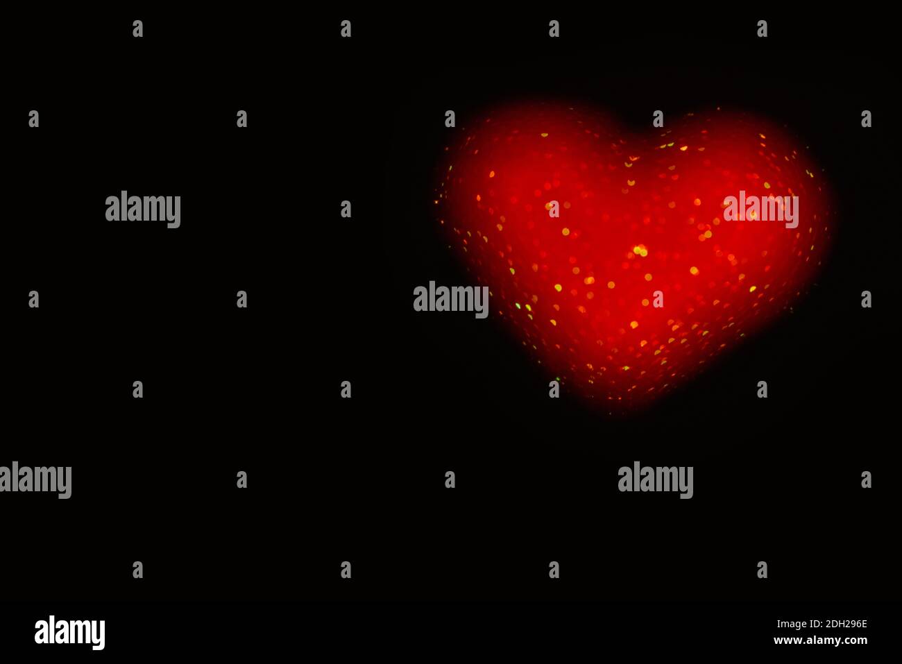 On black isolated background red blurred heart from bokeh. Greeting ...