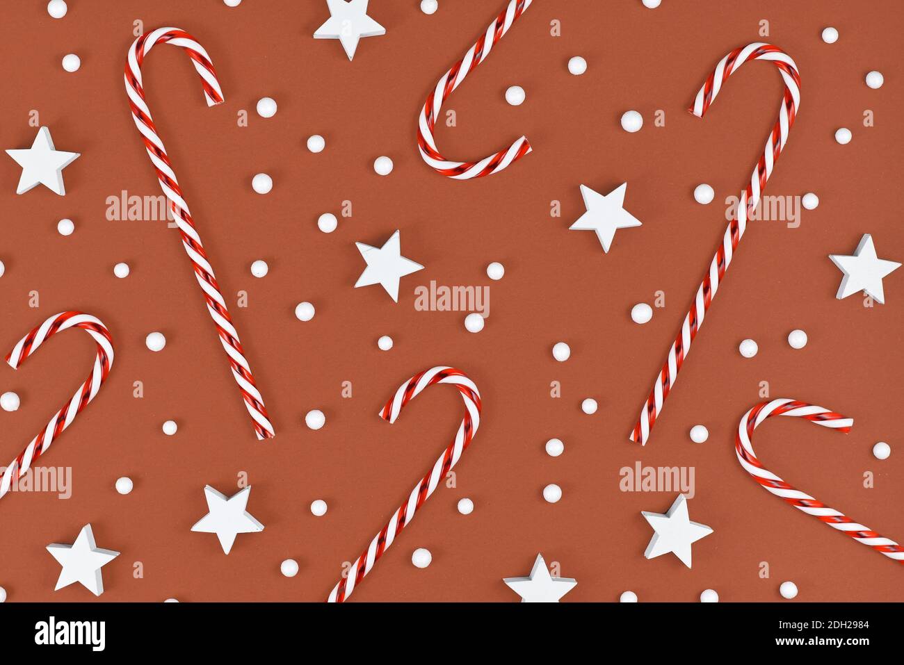 Christmas flat lay with candy canes and star and snow ornaments on ...