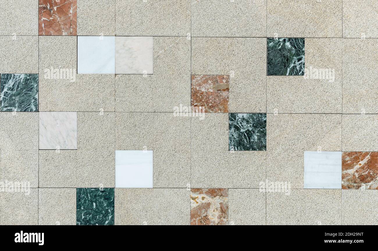 Concrete and stone wall with square tiles. Abstract background of a ...