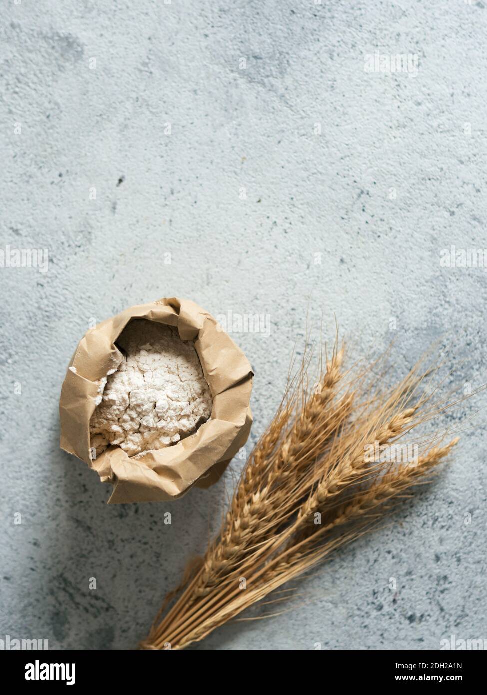 Wheat flour in paper bag on gray cement background Stock Photo - Alamy