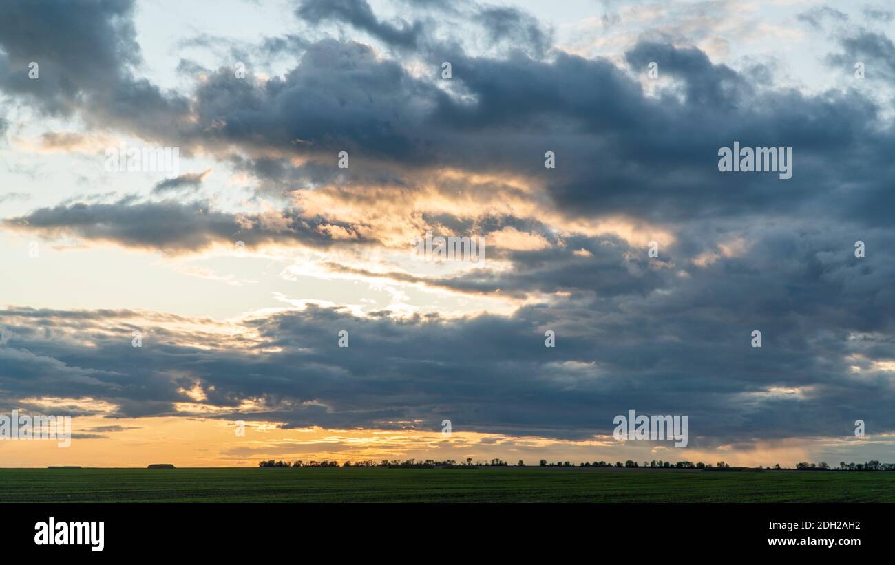 dark rain clouds over the field at dusk Stock Photo - Alamy