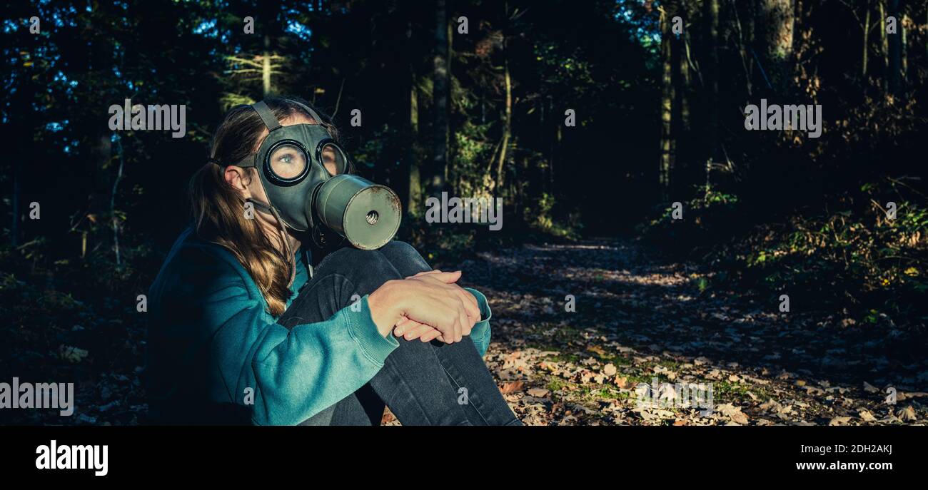 Girl with gas mask in forest at sunset Stock Photo - Alamy