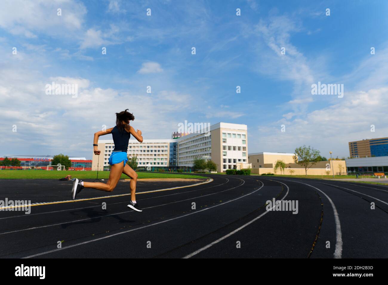 Athlete runner running on athletic track training her cardio. Woman ...