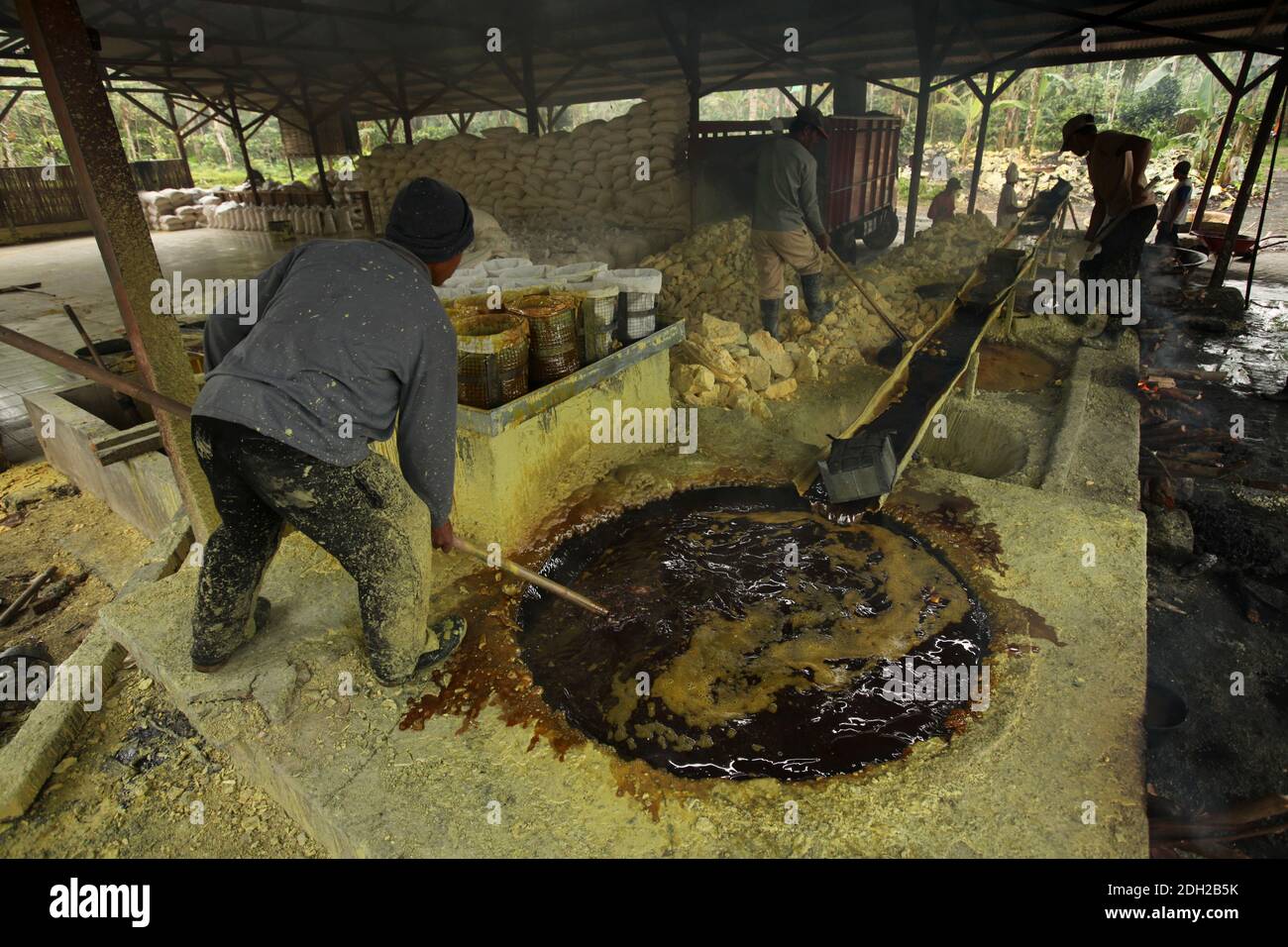 Factory worker loads the filtration system with molten sulphur from the ...