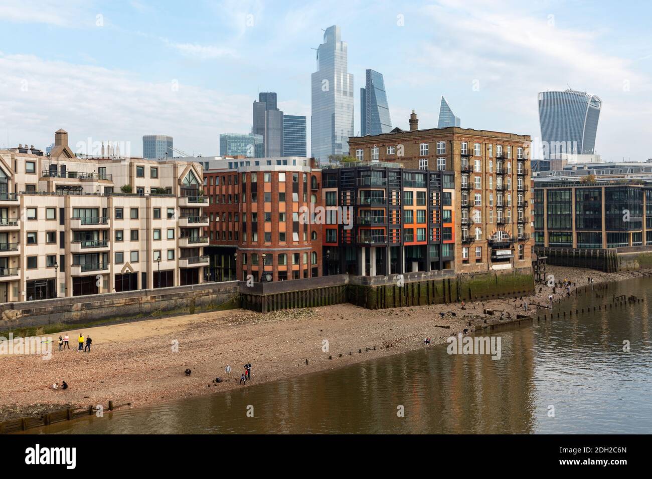 View of the Thames riverbank at low tide with apartment buildings and ...