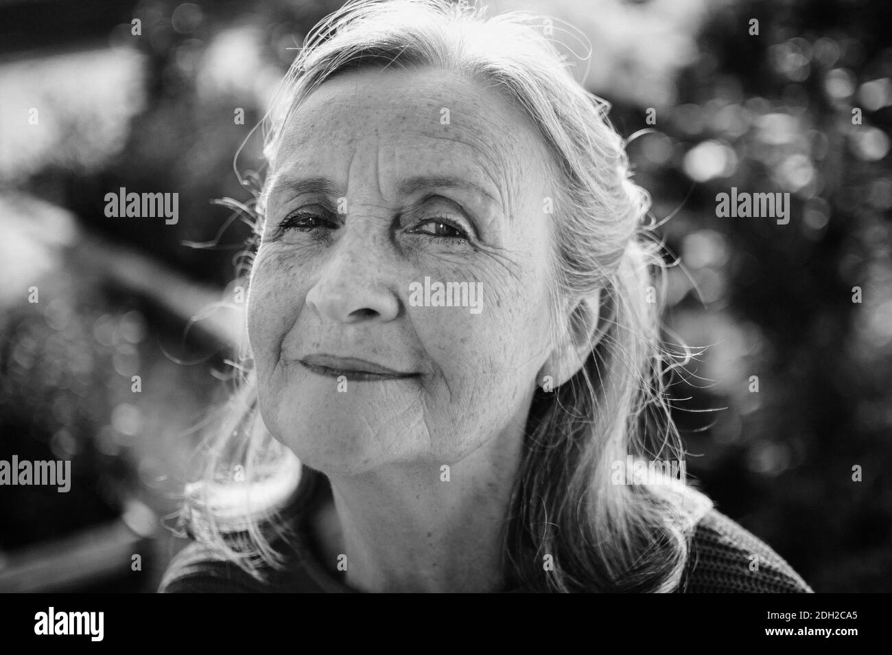 Black and white portrait of senior woman with grey hair and face with ...