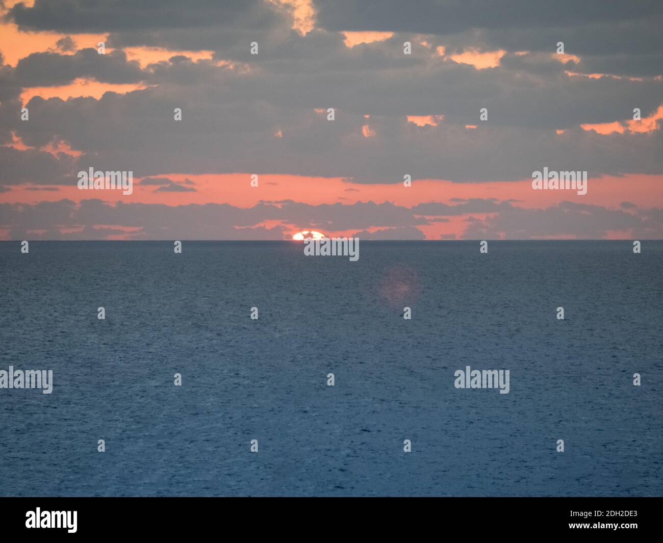 Sun disc over the sea at sunset Stock Photo - Alamy