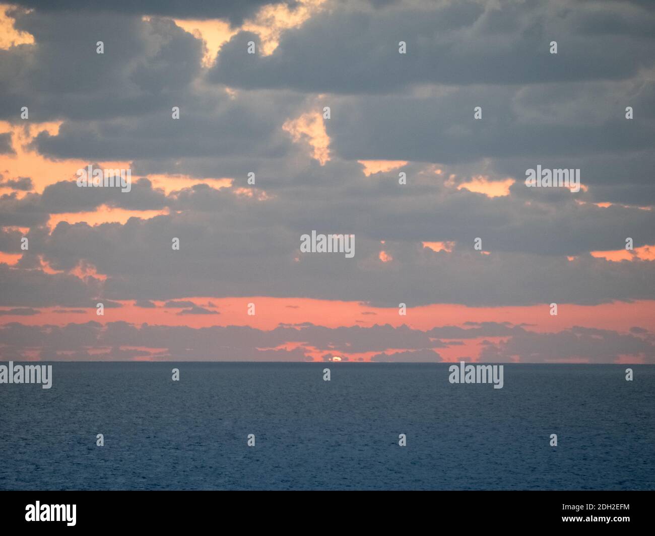 Sun disc over the sea at sunset Stock Photo - Alamy