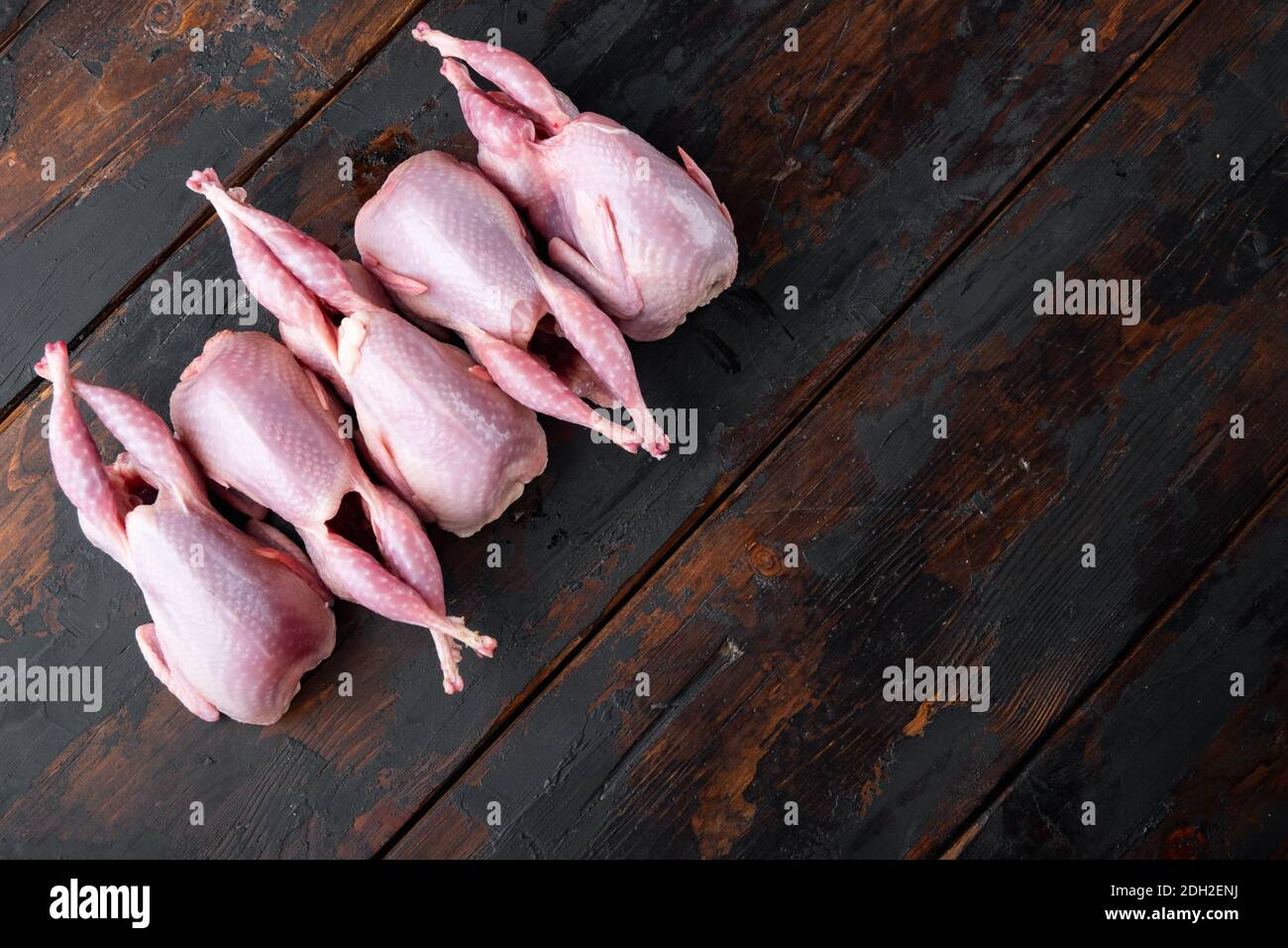 Fresh organic whole quail meat, top view, on dark wooden background ...