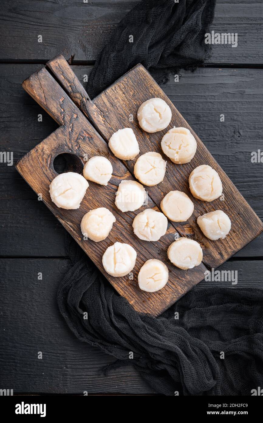 Scallops fresh meat, top view, on black wooden background Stock Photo ...