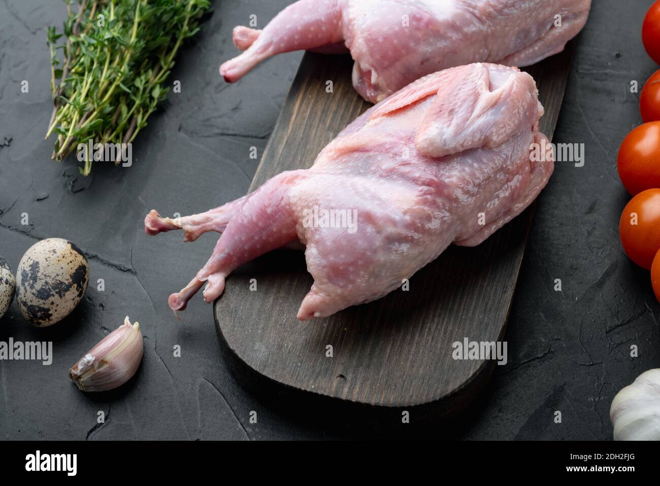 Homemade eco friendly raw quail, on black textured background Stock ...