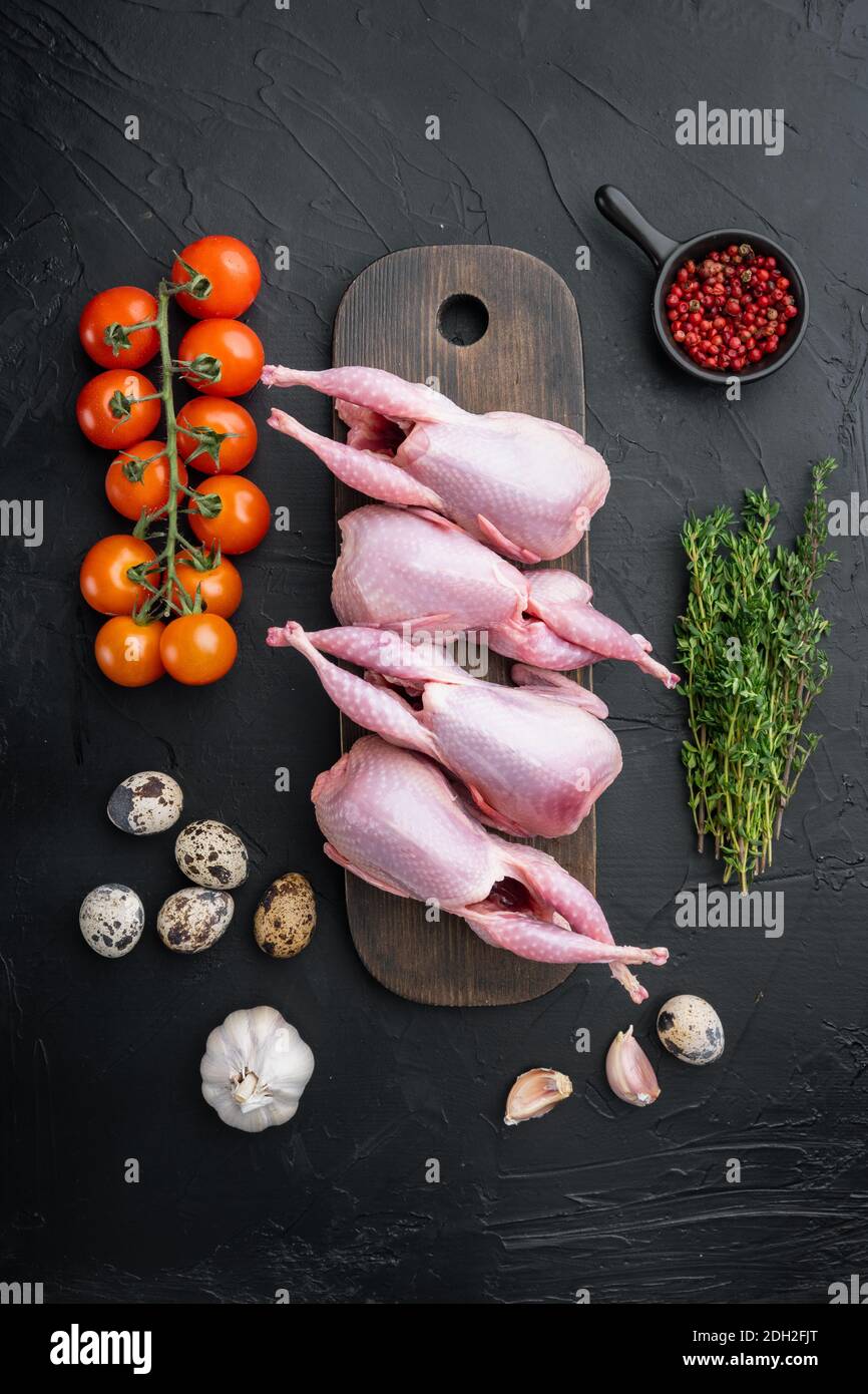 Homemade eco friendly raw quail, top view, on black textured background ...