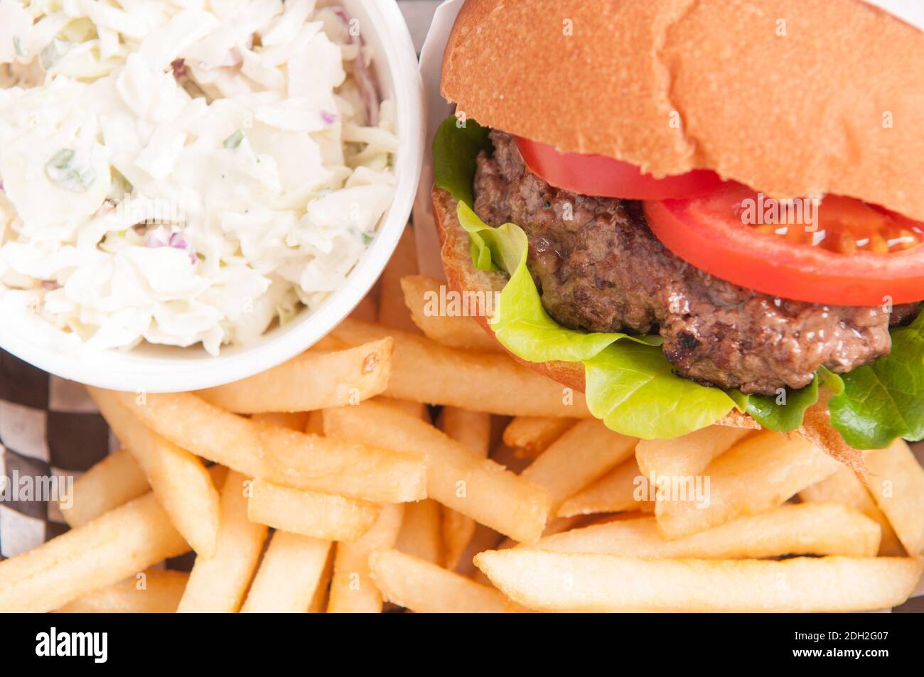 ethical meat beef hamburger with home made coleslaw and fries in a take ...