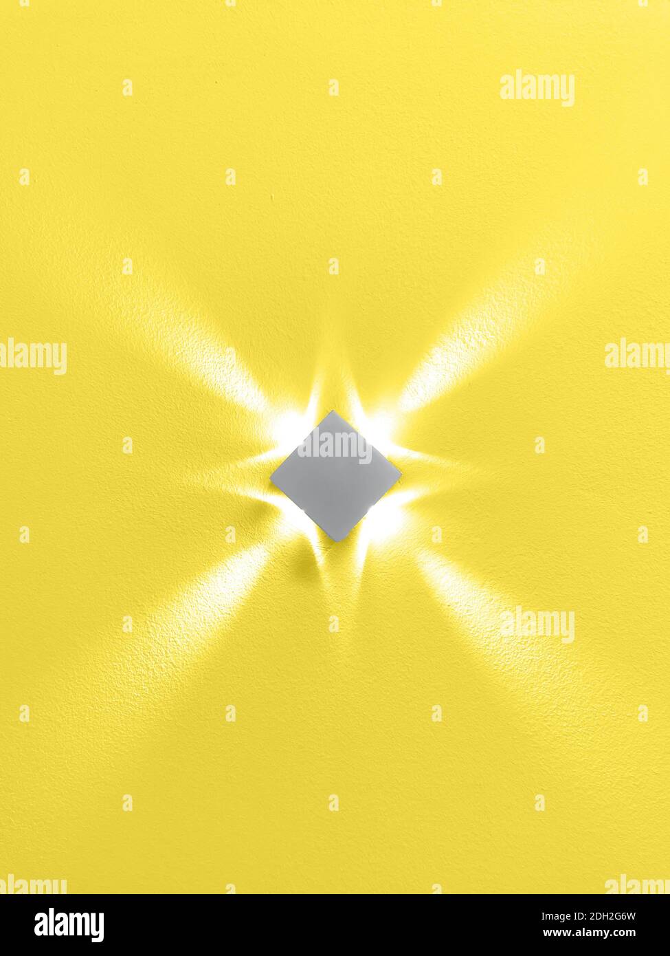decorative square gray wall lamp with rays of light on yellow ...