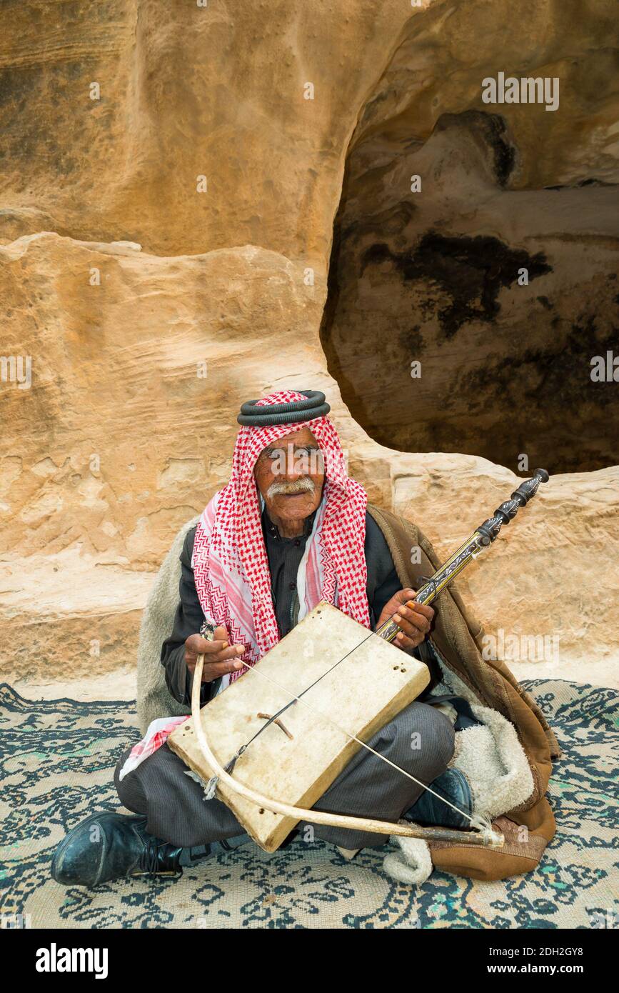 Old bedouin man with his self made oud in Little Petra (or Siq al-Barid ...