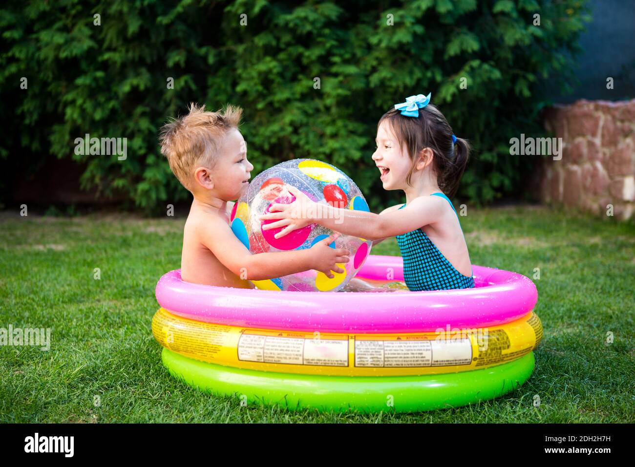 Two happy kids beach ball hi-res stock photography and images - Alamy