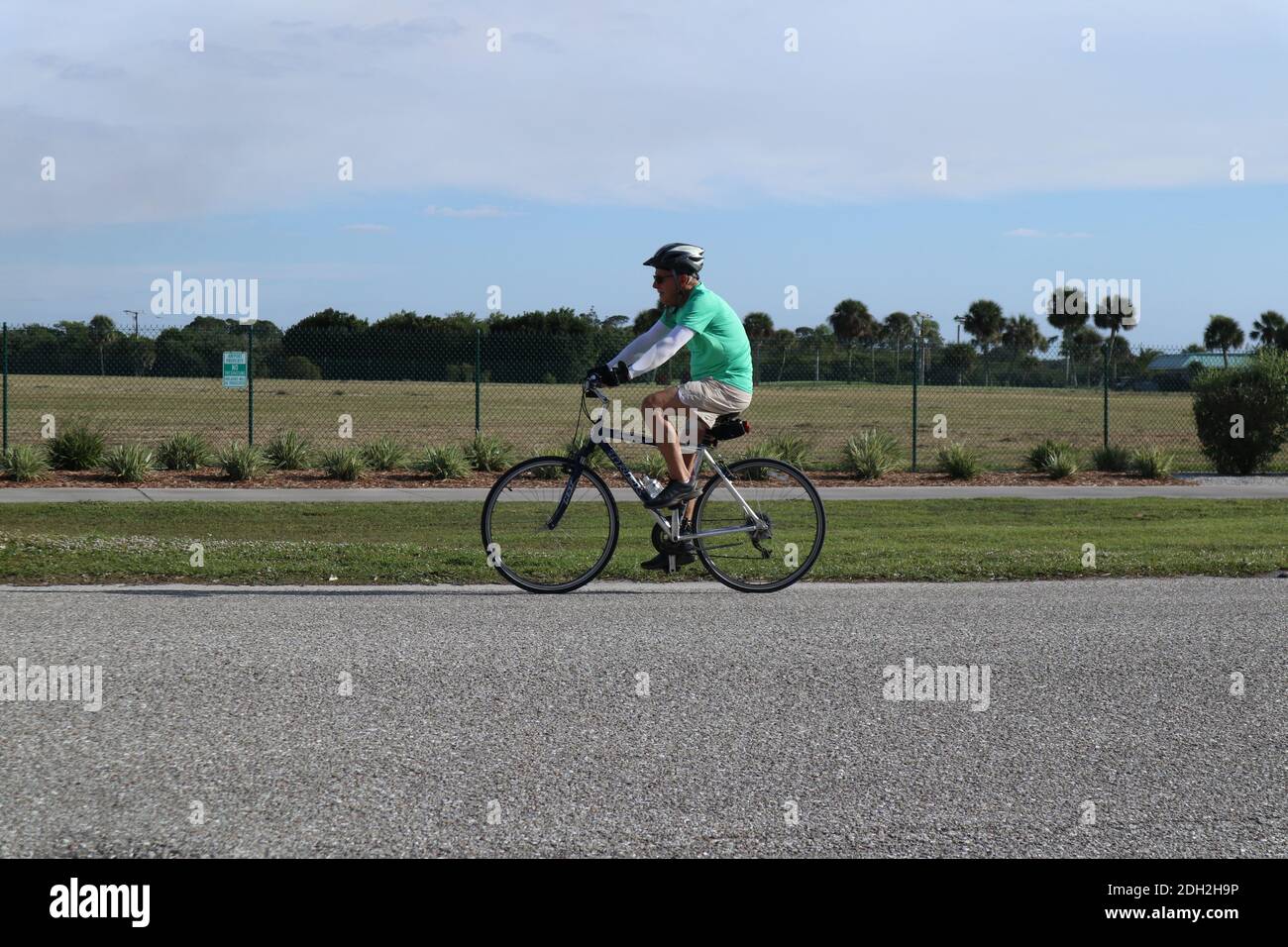Older man riding a bike Stock Photo - Alamy