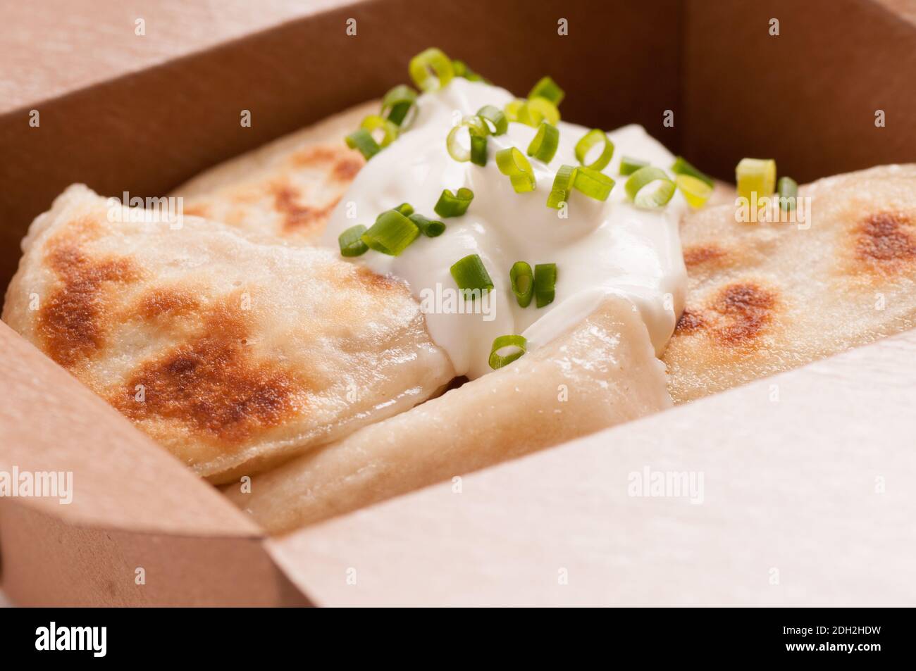take out pierogi or perogie with sour cream, food truck style Stock ...