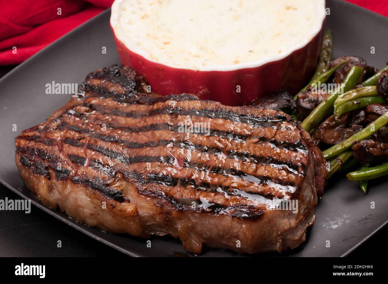 char grilled ribeye beef steak with cauliflower gratin and beans with ...