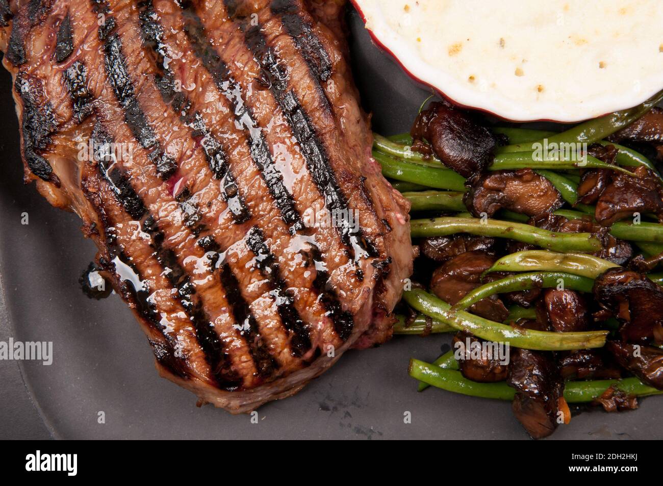 char grilled ribeye beef steak with cauliflower gratin and beans with ...