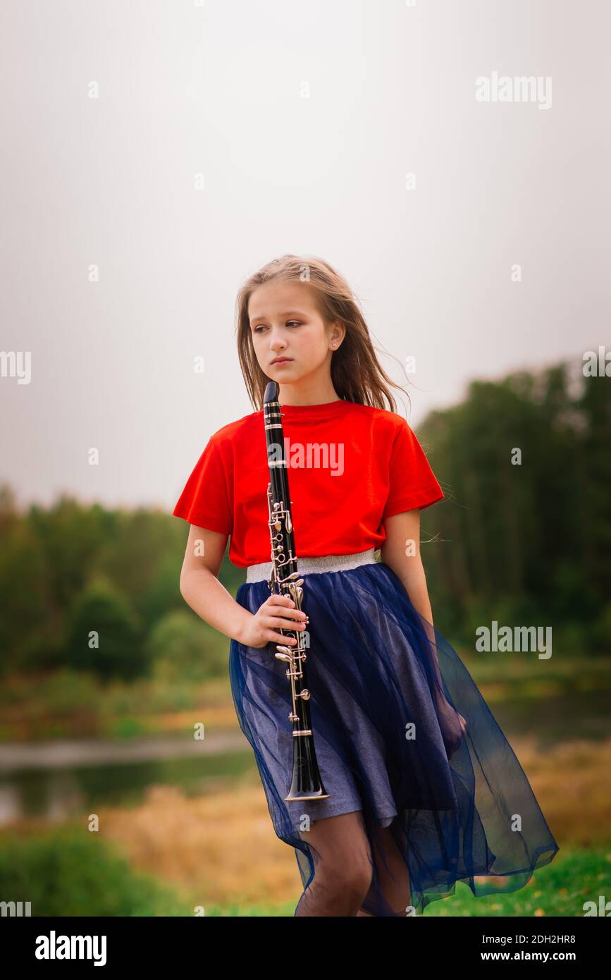 Young attractive girl playing clarinet in fall park Stock Photo - Alamy