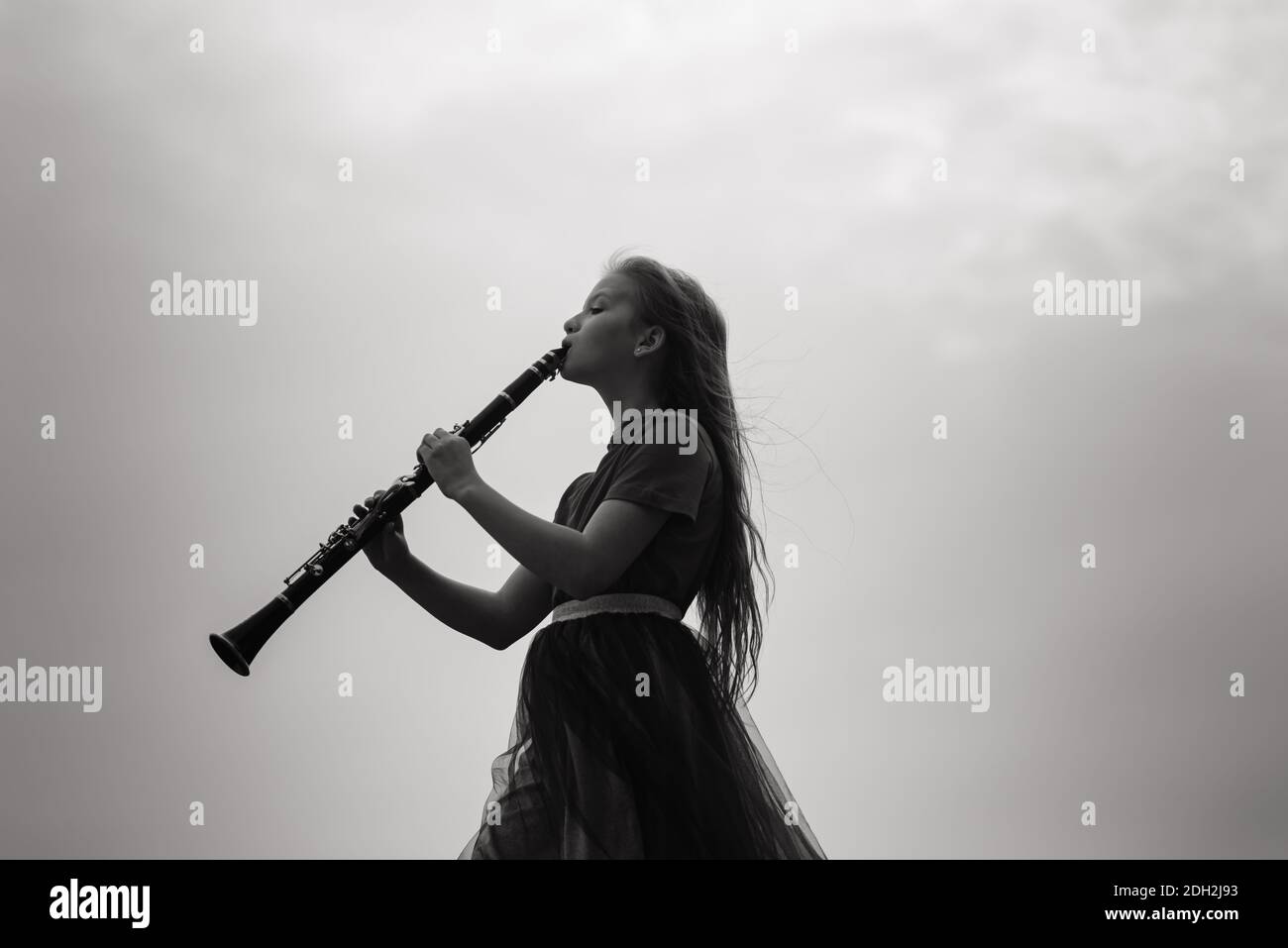 Young attractive girl playing clarinet in fall park Stock Photo - Alamy