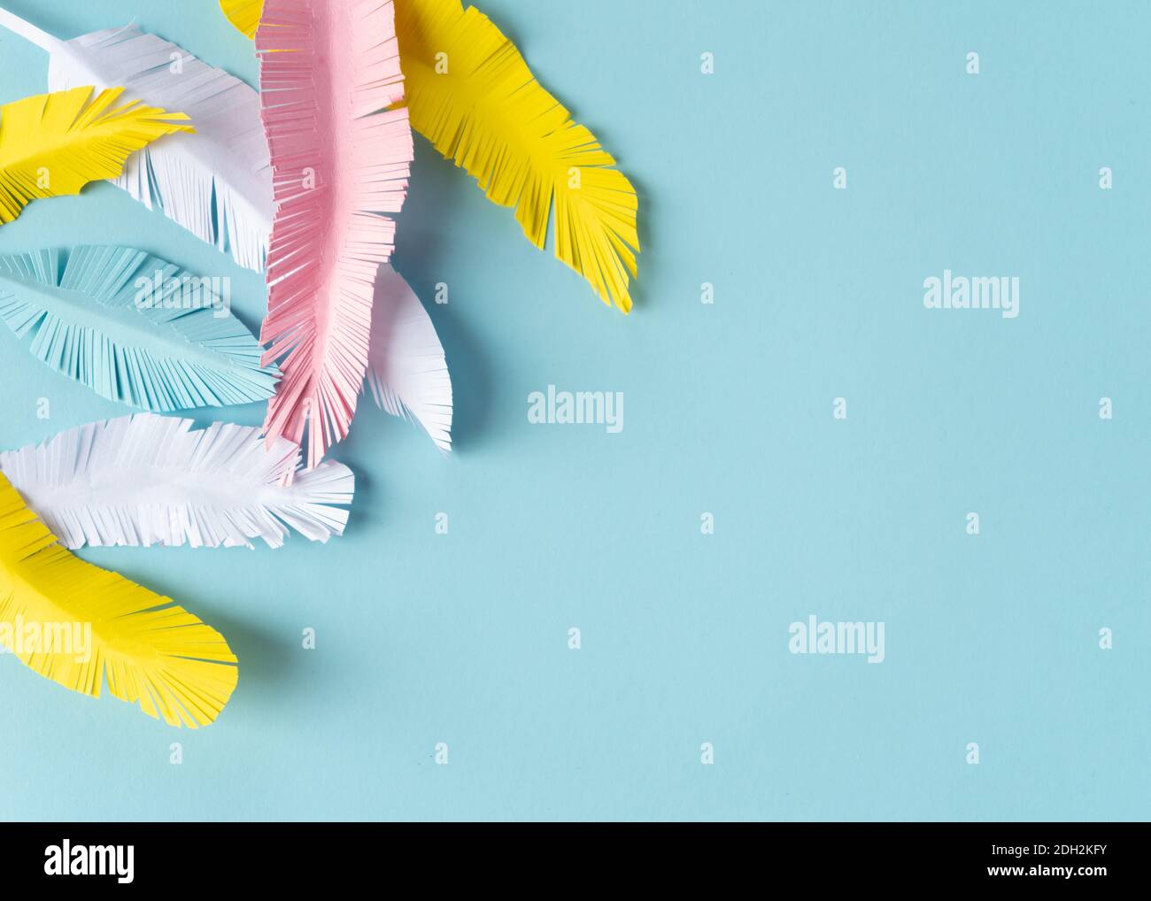colorful paper feathers on blue background with copy space Stock Photo ...