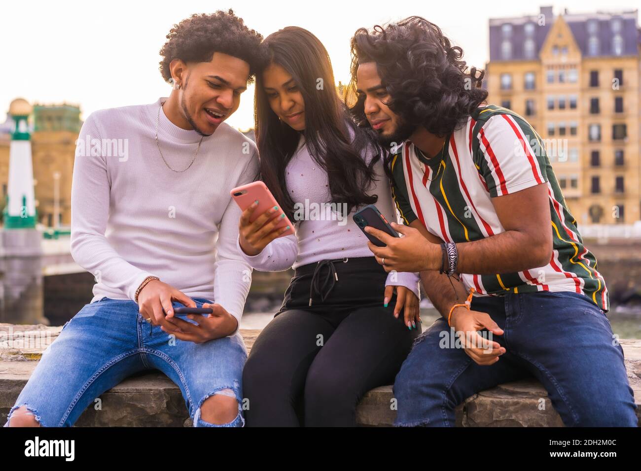 A shallow focus shot of young Latin friends having fun and watching ...
