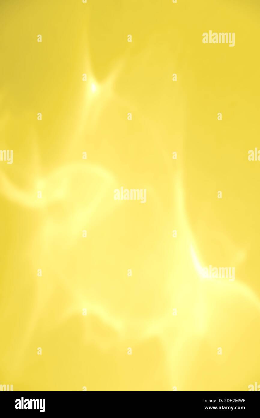 Abstract glass reflection yellow background. Neon illuminating foil in ...