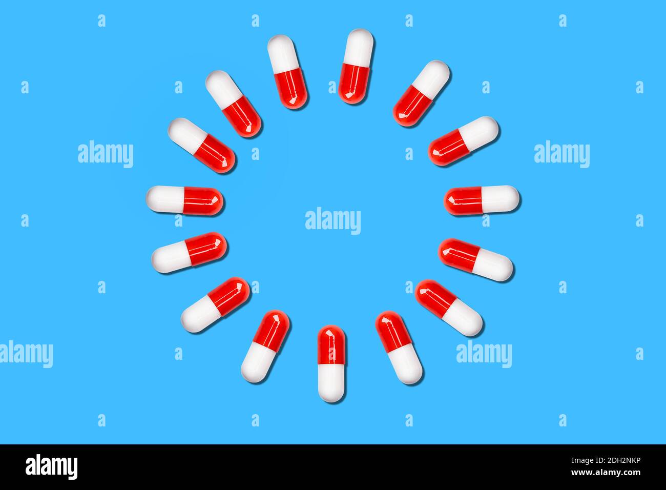 circle of medical capsules on a blue background Stock Photo - Alamy