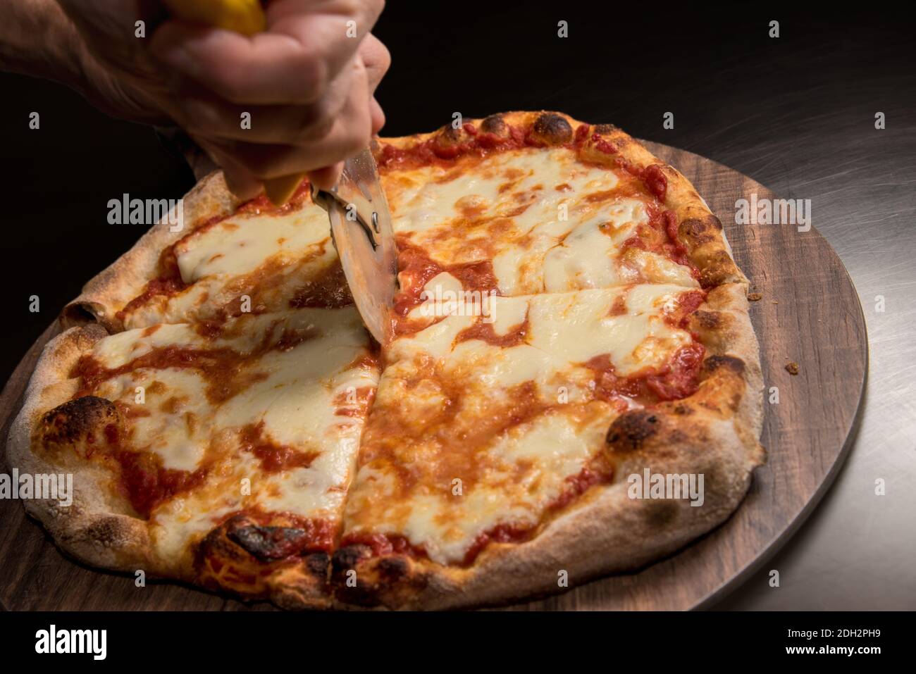 Hand cutting pizza hi-res stock photography and images - Alamy