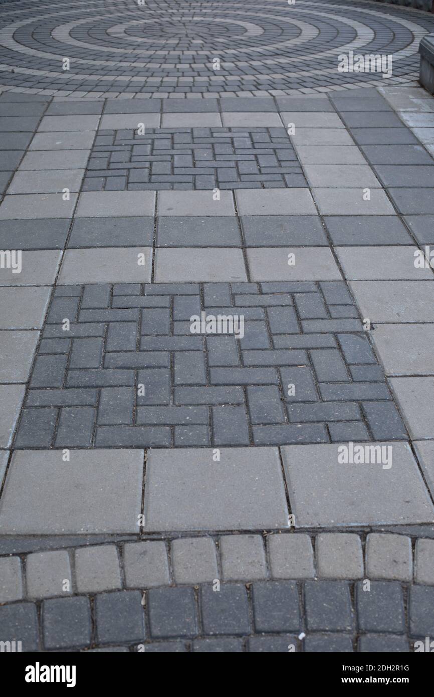 The pedestrian area is cobbled with gray stone. Geometric pattern on ...