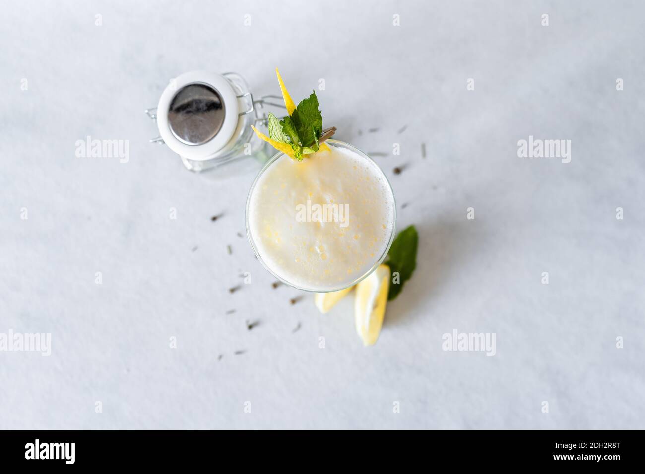 A top view of a refreshing drink decorated with lemon peel and mint ...