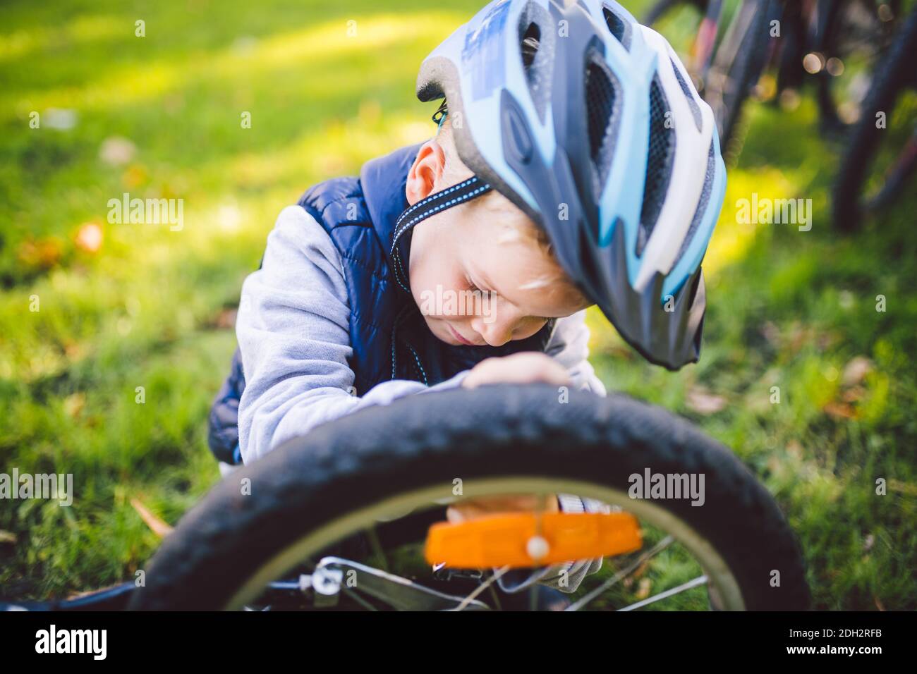 Cyclist boy Bike repair. little boy fixing his bike. Children mechanics ...