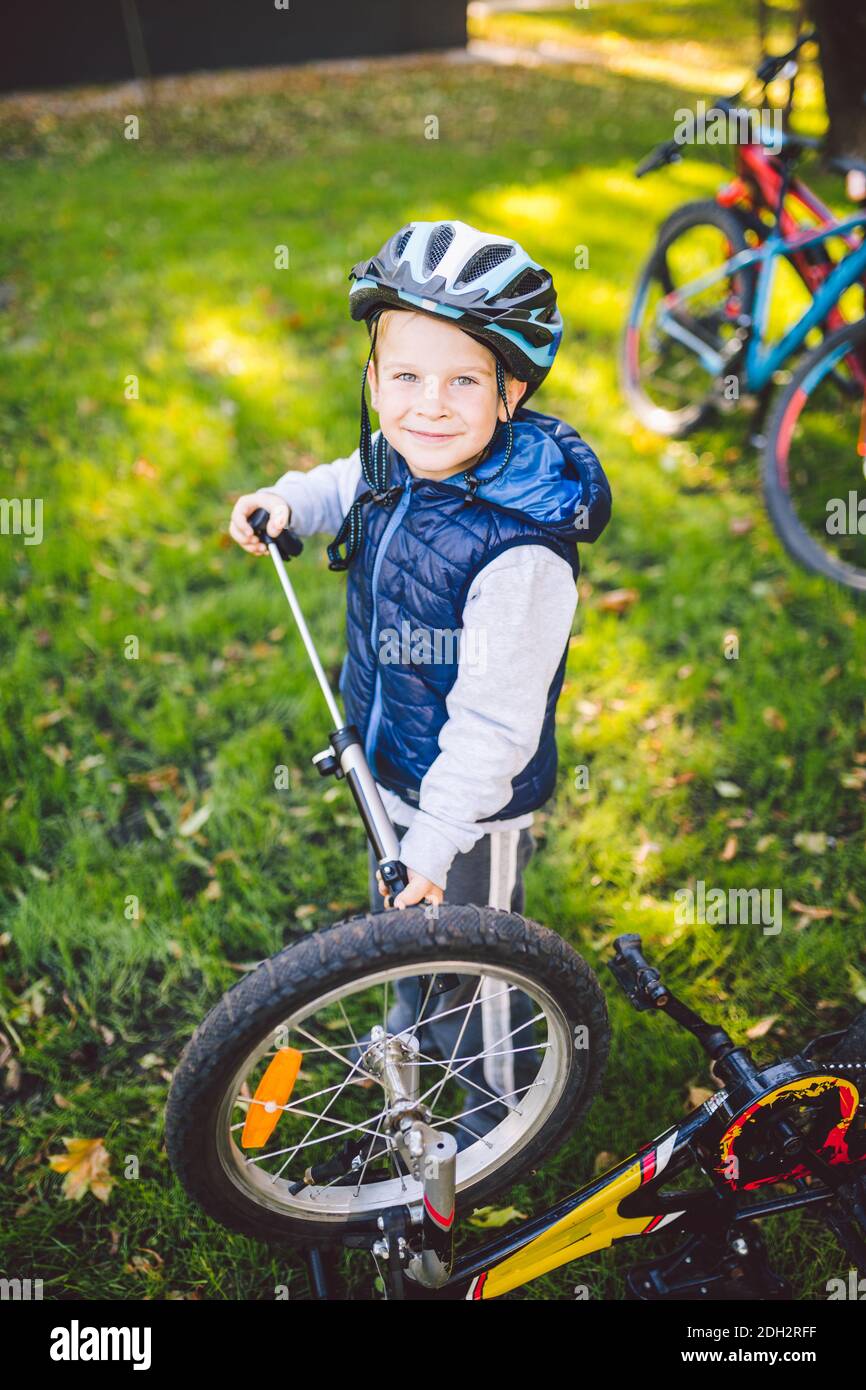 Cyclist boy Bike repair. little boy fixing his bike. Children mechanics ...