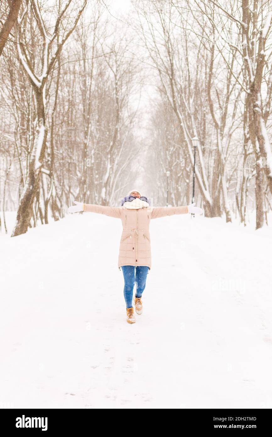 Young girl in a snowy forest in winter. Portrait of a girl in a winter ...