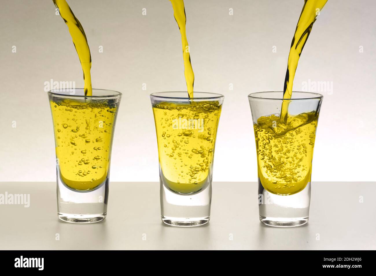 Three alcoholic multicolored alcoholic shots for advertising layout ...