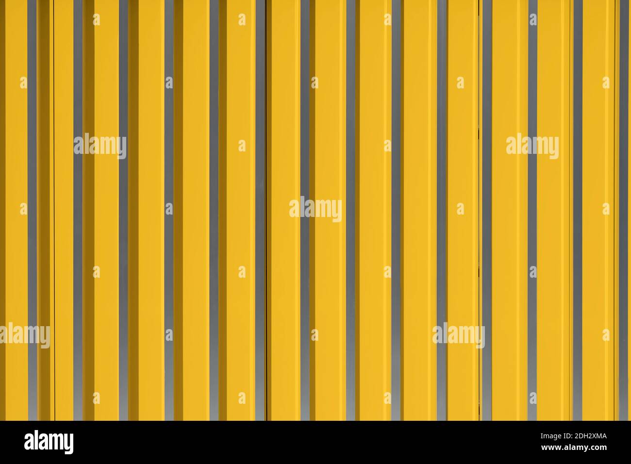 Building with wall of yellow metal. Corrugated texture, galvanized ...