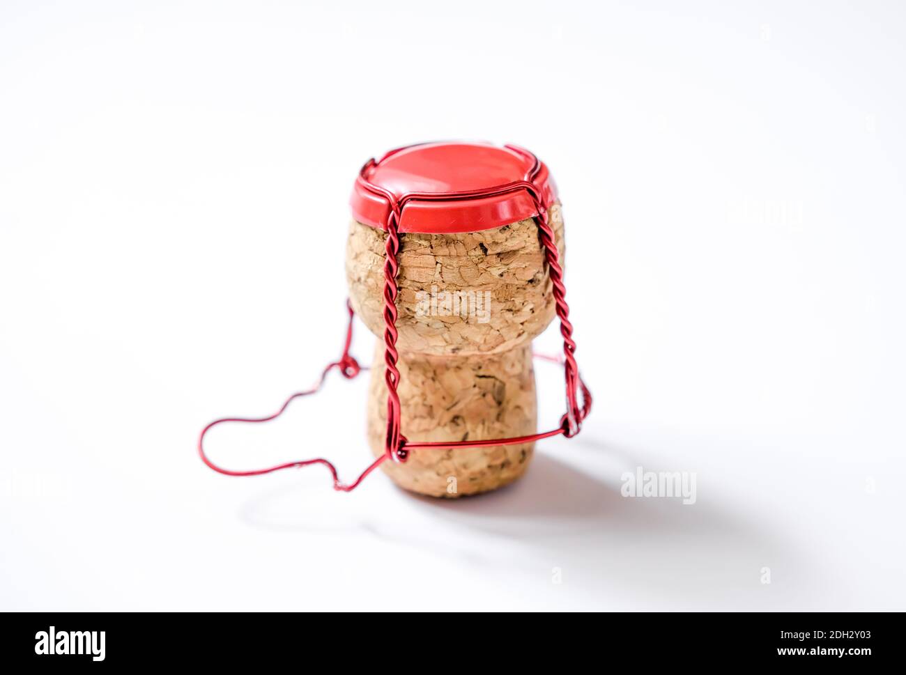 Champagne cork with wire cage isolated on white Stock Photo - Alamy