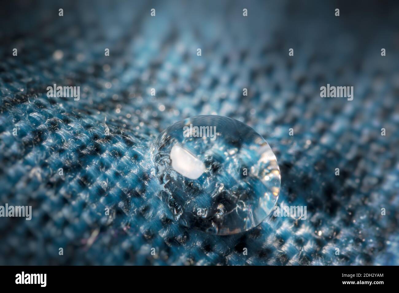 Close-up view on water drop on blue waterproof fabric Stock Photo - Alamy