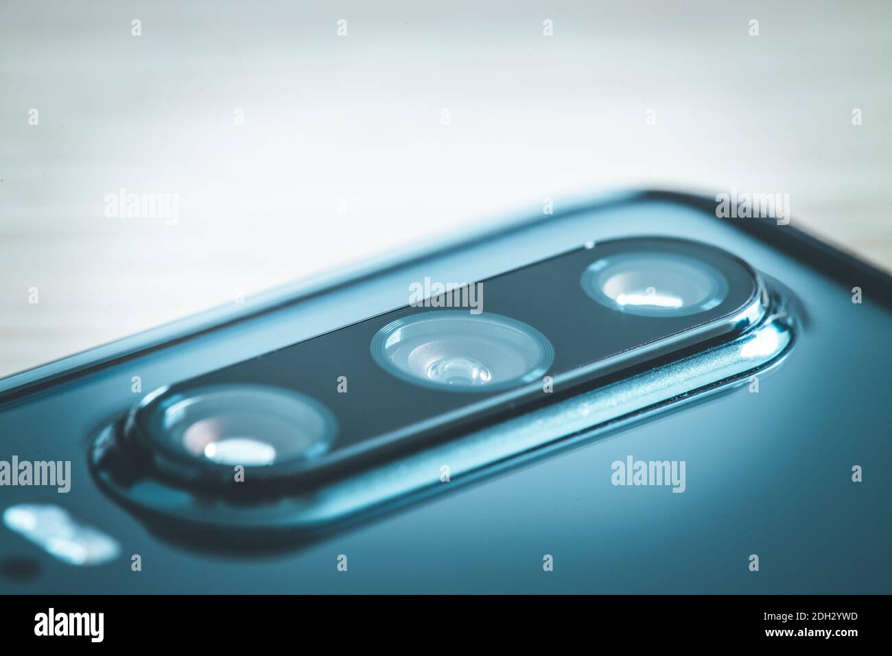 Mobile phone with triple lens. Camera innovation Stock Photo - Alamy