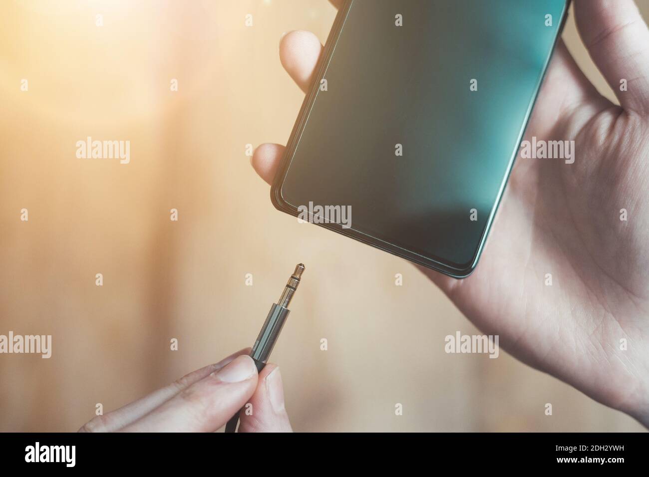 Audio jack concept: Connecting audio jack to a black mobile phone ...