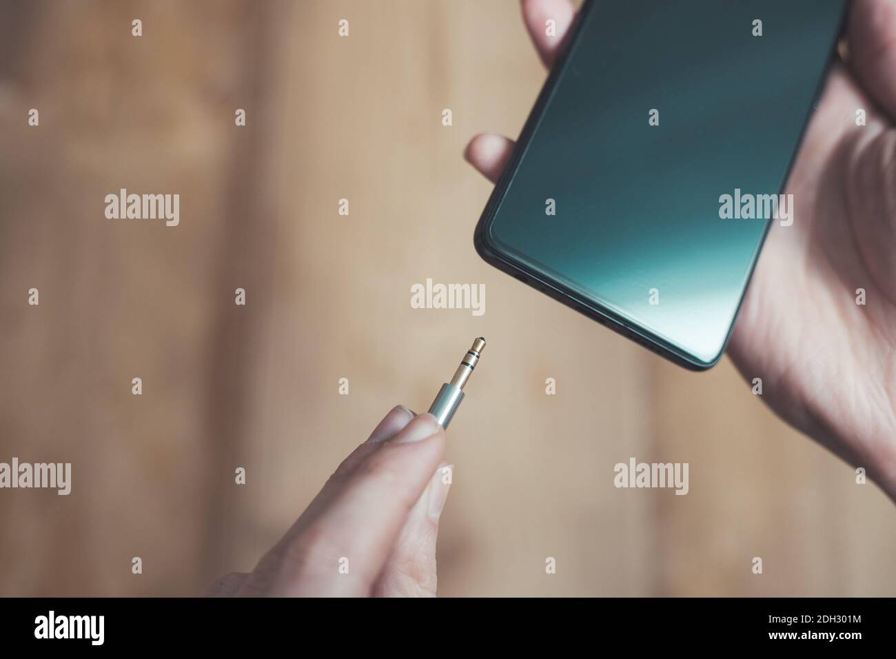 Audio jack concept: Connecting audio jack to a black mobile phone ...