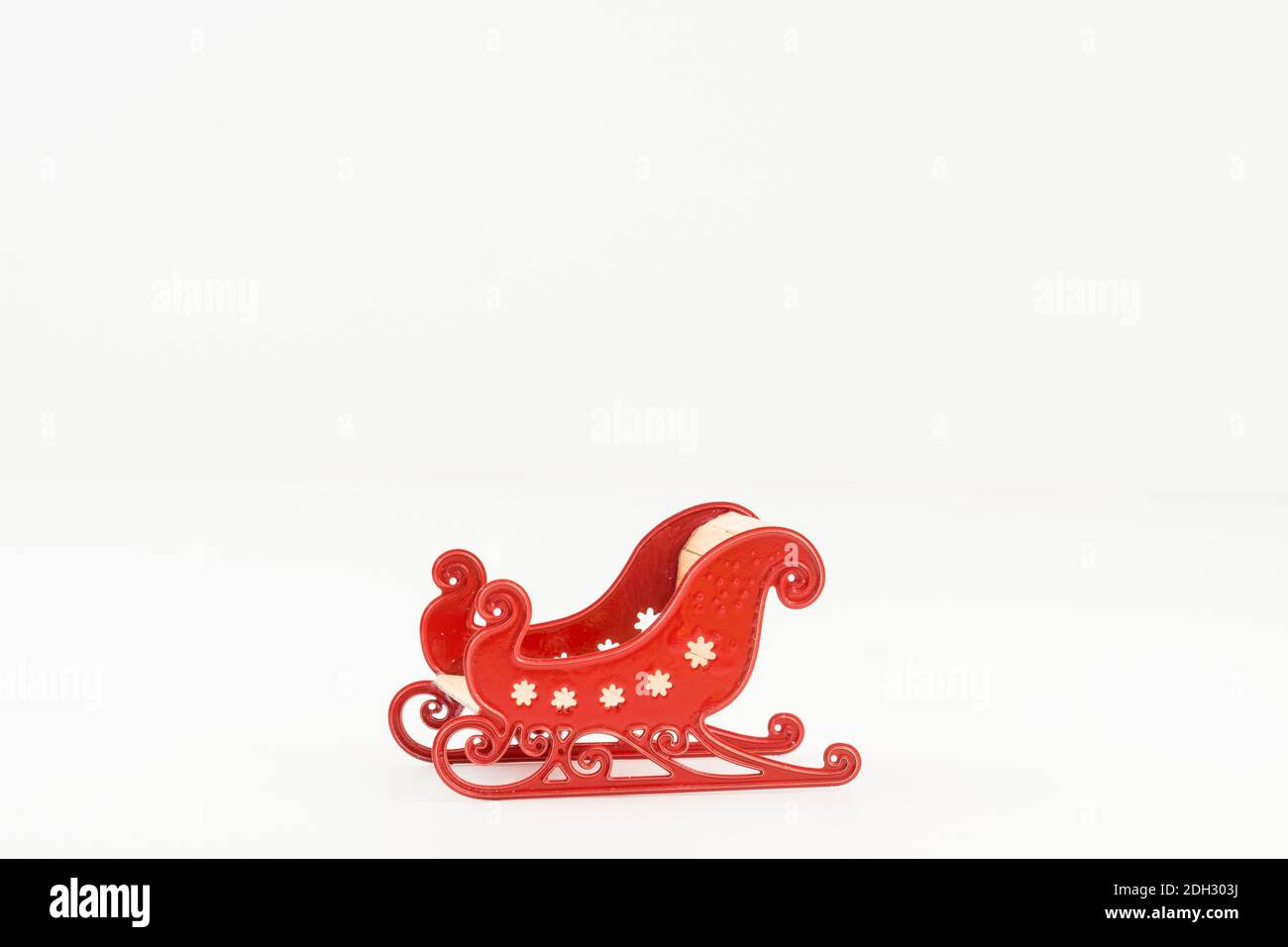 A side view of a Santa's sleigh ornamented with small snowflakes and ...